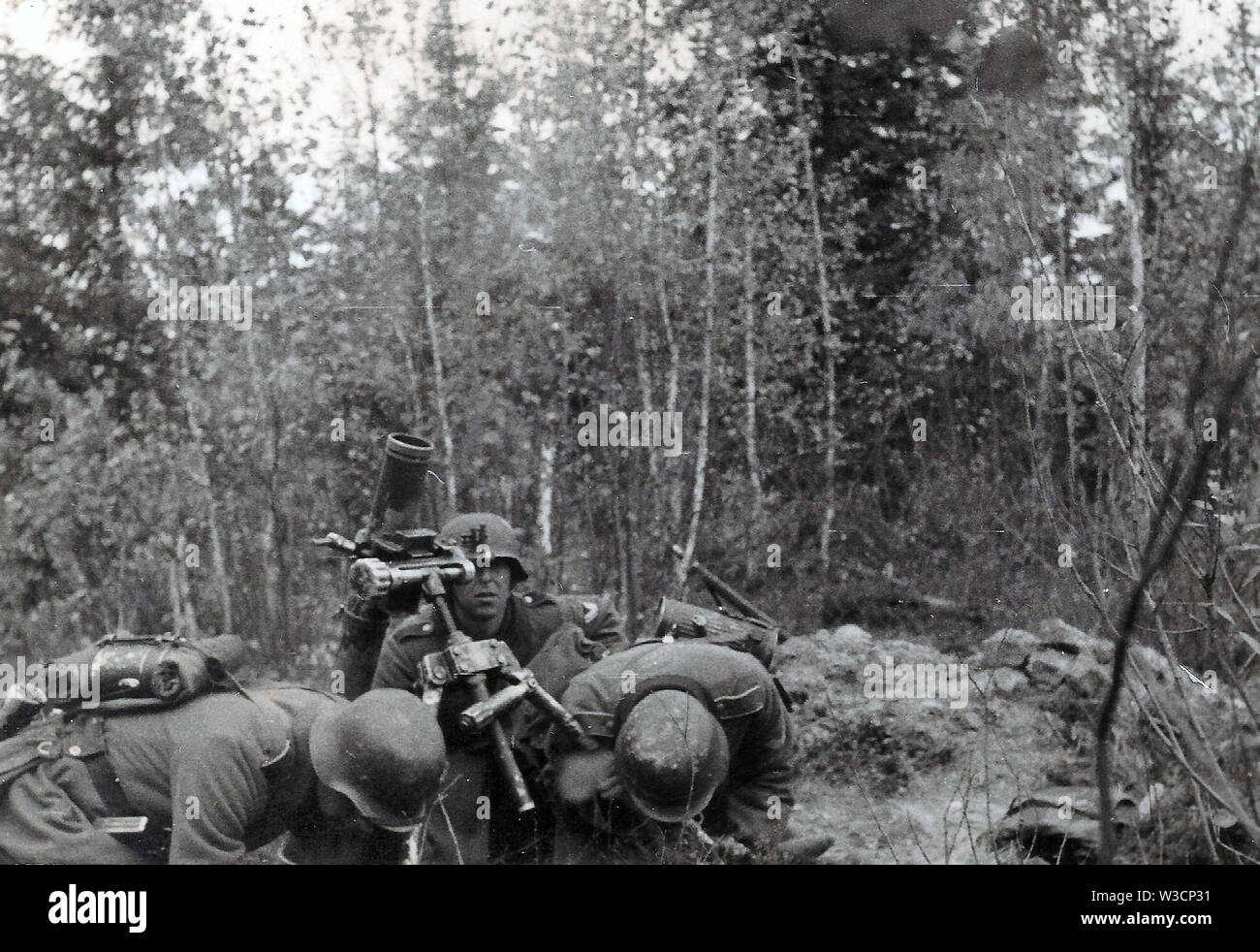 German Soldiers fire a 8cm Mortar in the thick Forest area Wolchow 1942 ...