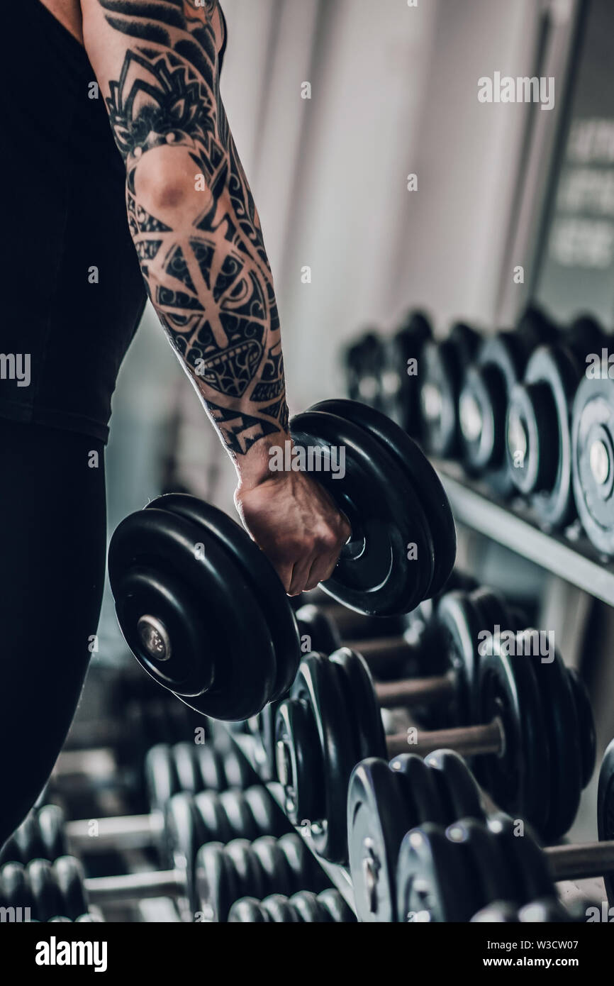 close up.dumbbell in the hand of a bodybuilder Stock Photo - Alamy