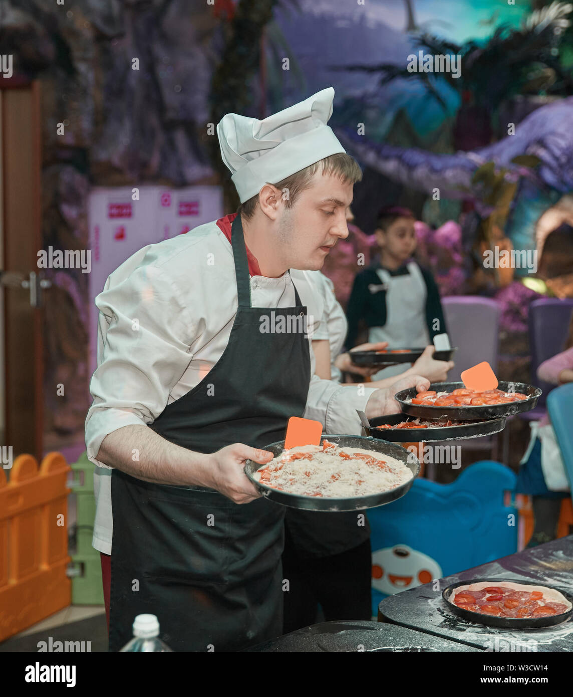 chef is holding a freshly prepared pizza . delicious food Stock Photo ...