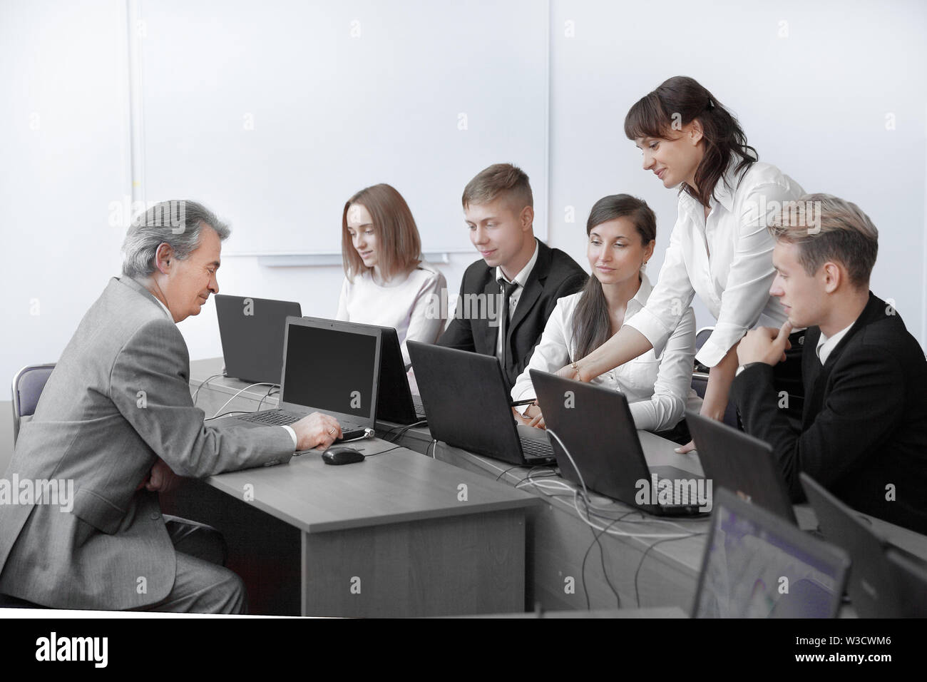 Young business team using laptops during an informal meeting Stock ...