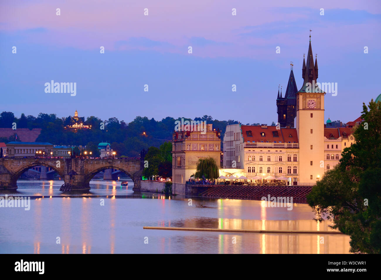 Prague, riverside in the evening. Charles Bridge and Novotnevo Lavka ...