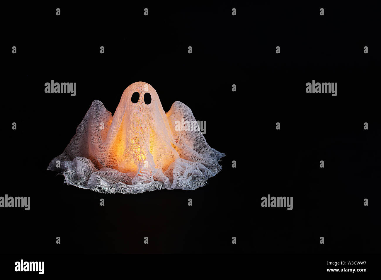 Halloween ghost of starch and gauze on black background. Gift idea ...