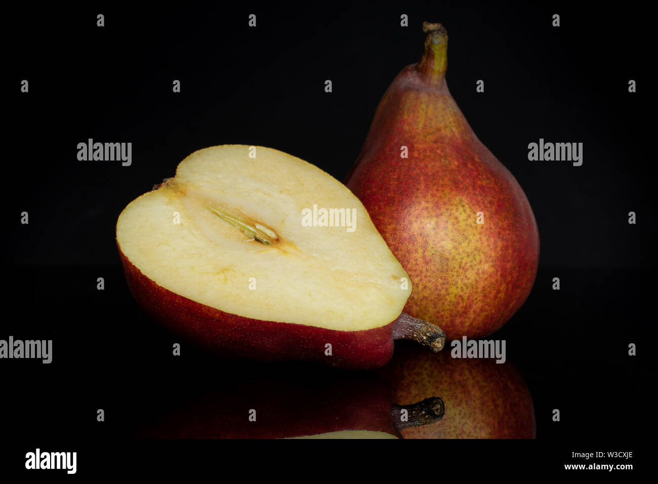 Group of one whole one half of fresh dark red pear anjou cross section ...