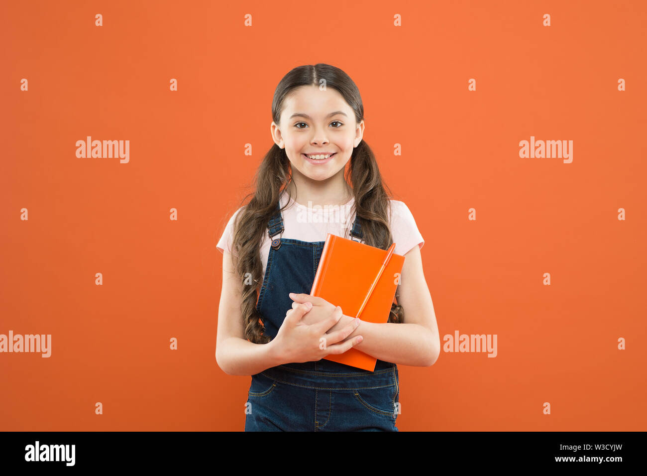 favorite book. happy little girl with notebook. reading book ...