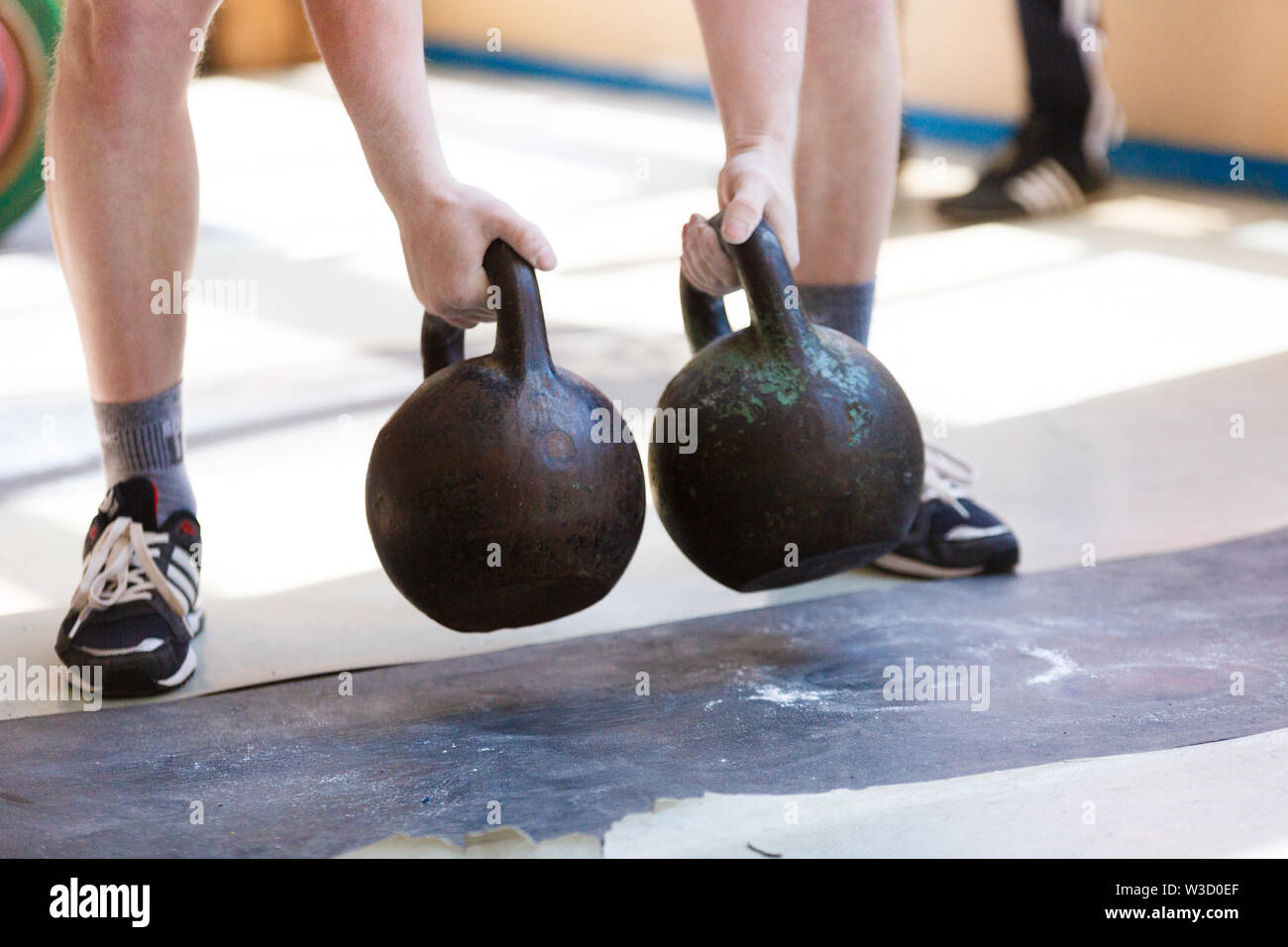 Athlete in weight lifting. Two weights of 24 kg Stock Photo - Alamy