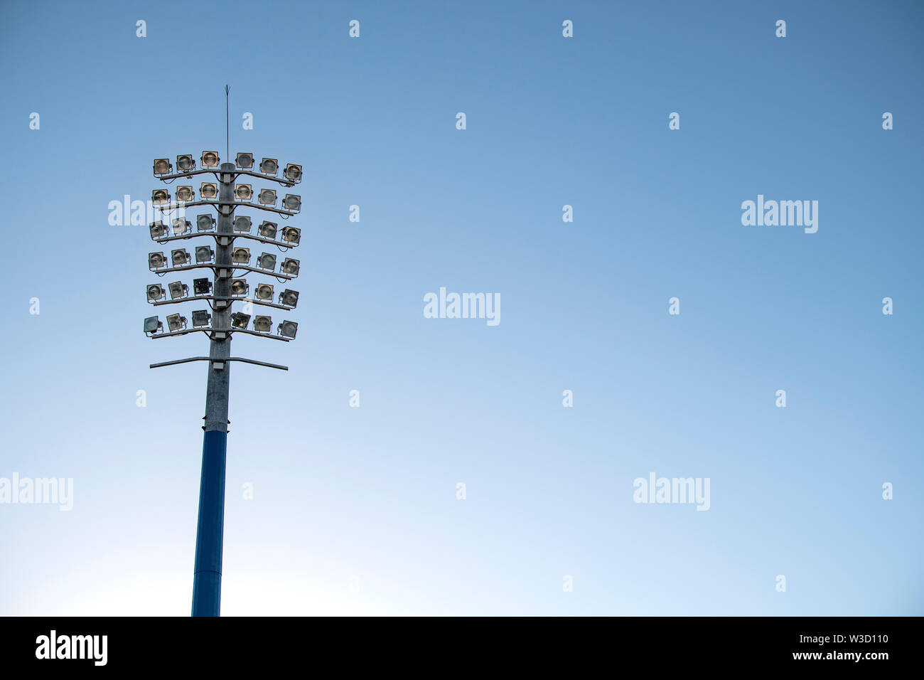 Sports stadium light tower during the day, set against a blue sky Stock ...