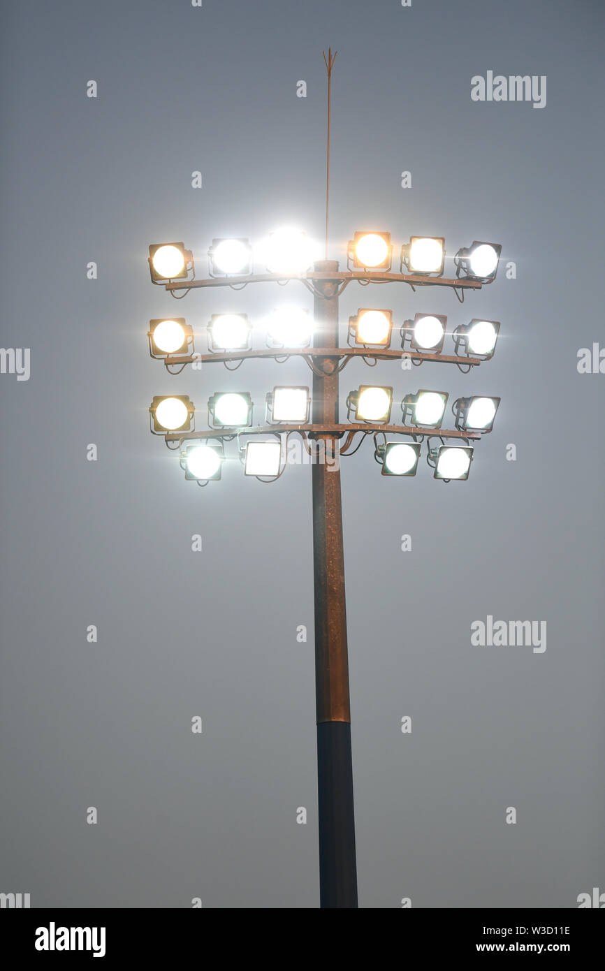 Sports stadium light tower during the night, set against a dark sky ...