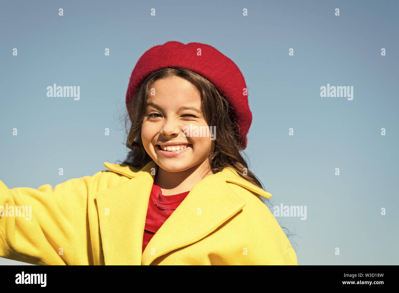 Things gonna be alright. Girl wink cheerful face blue sky background ...