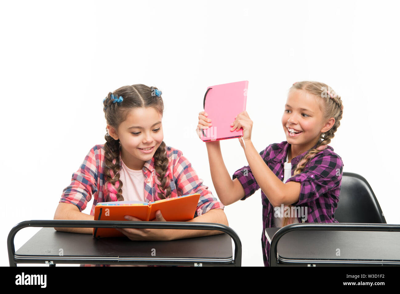 Books are not for hitting. Naughty little girl spoiling her classmate ...