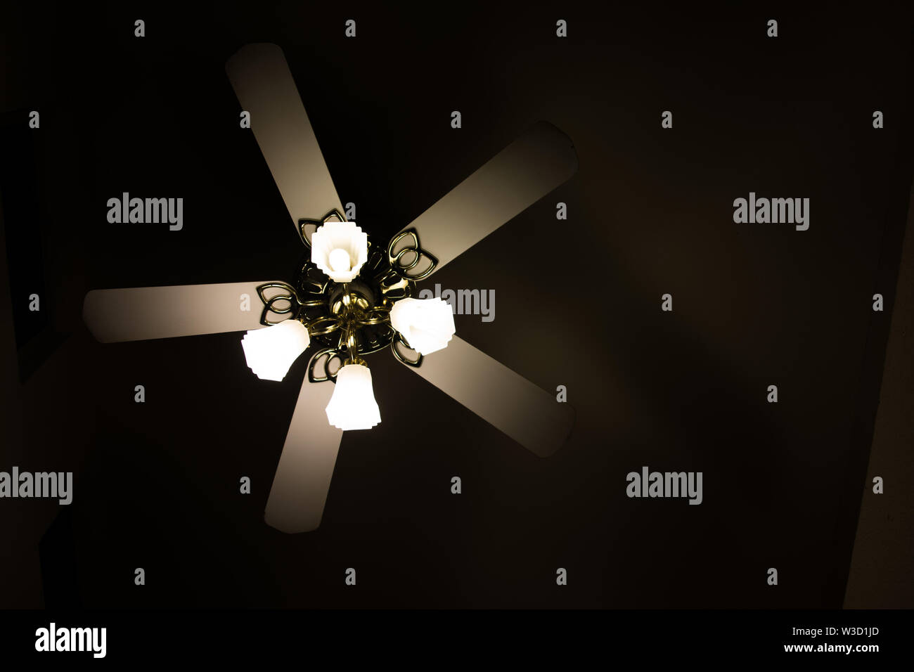 Ceiling fan with lights in the dark Stock Photo - Alamy