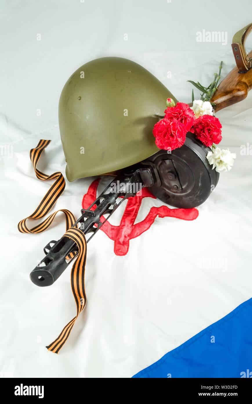 Flowers and army equipment on a studio background Stock Photo - Alamy