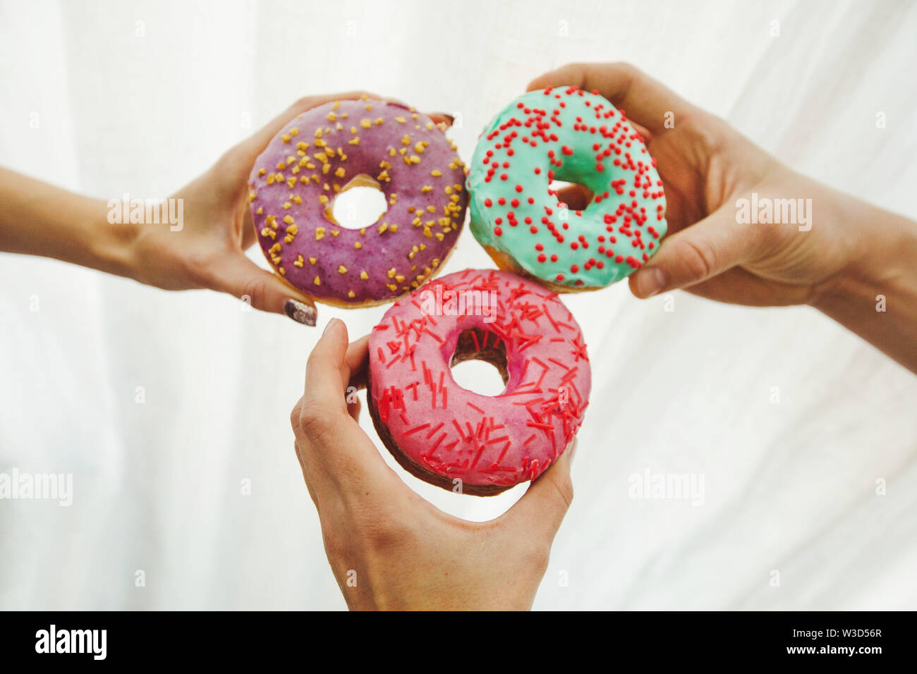 Hands holding donut hi-res stock photography and images - Alamy