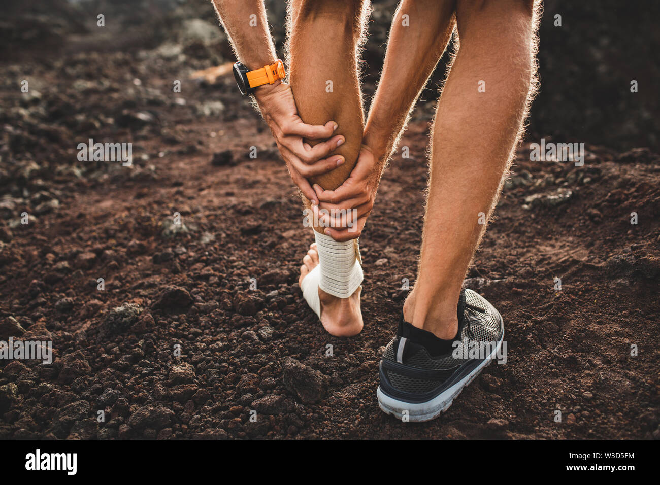 Male runner holding injured calf muscle close-up and suffering with ...