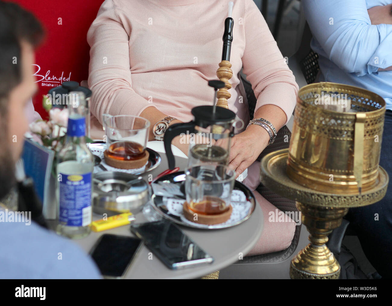 Wien, Austria. 11th July, 2019. Guests smoke a water pipe and drink tea ...