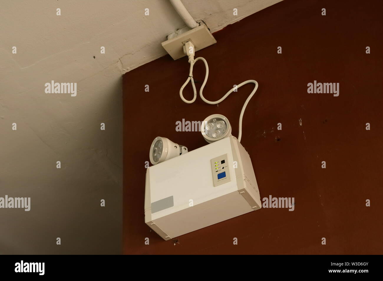 Closeup of emergency light fixed to the wall of a building Stock Photo ...
