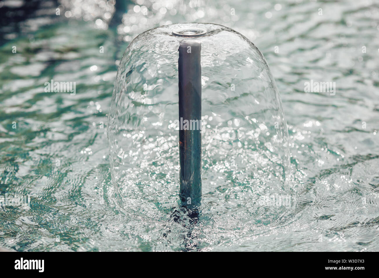 Fountain with copper pipes, foamy blue water and jets Stock Photo - Alamy