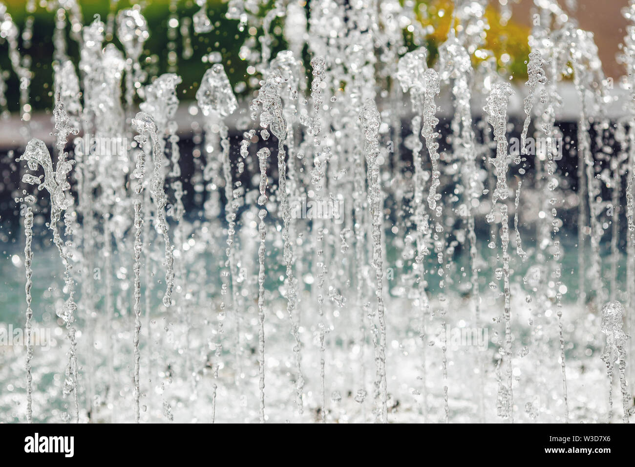 Fountain with copper pipes, foamy blue water and jets Stock Photo - Alamy