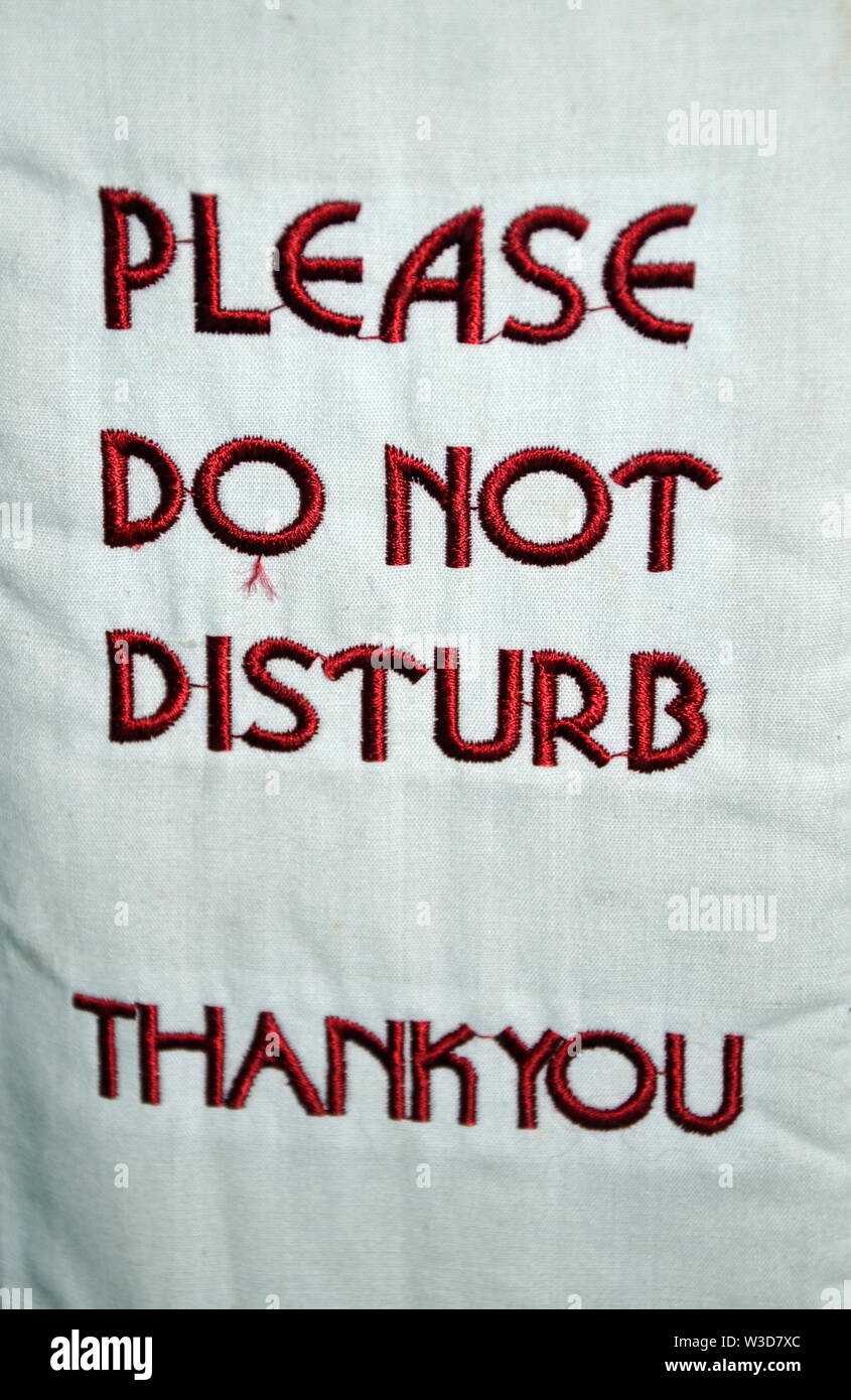 A 'Please Do Not Disturb Thank You' sign hanging on a hotel room door ...