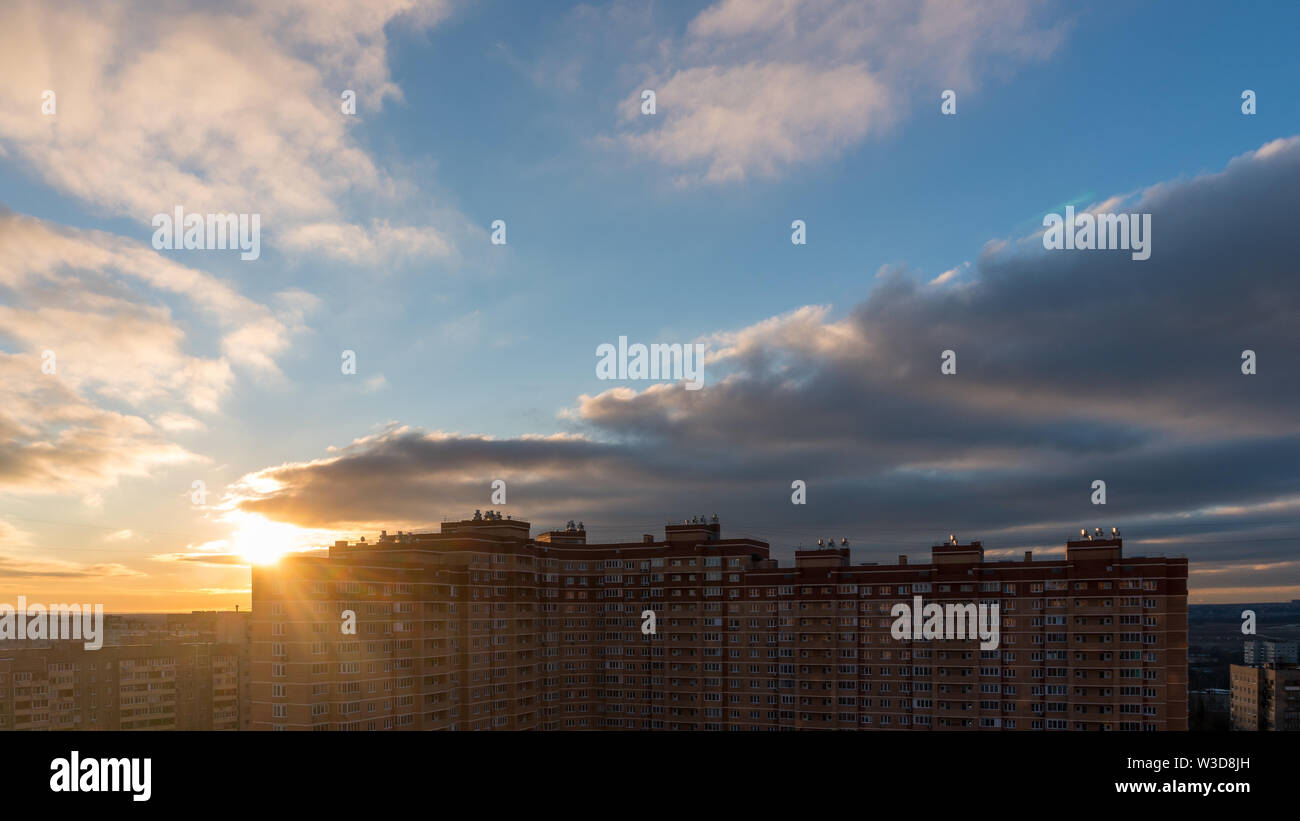 Sun rising over city Stock Photo - Alamy