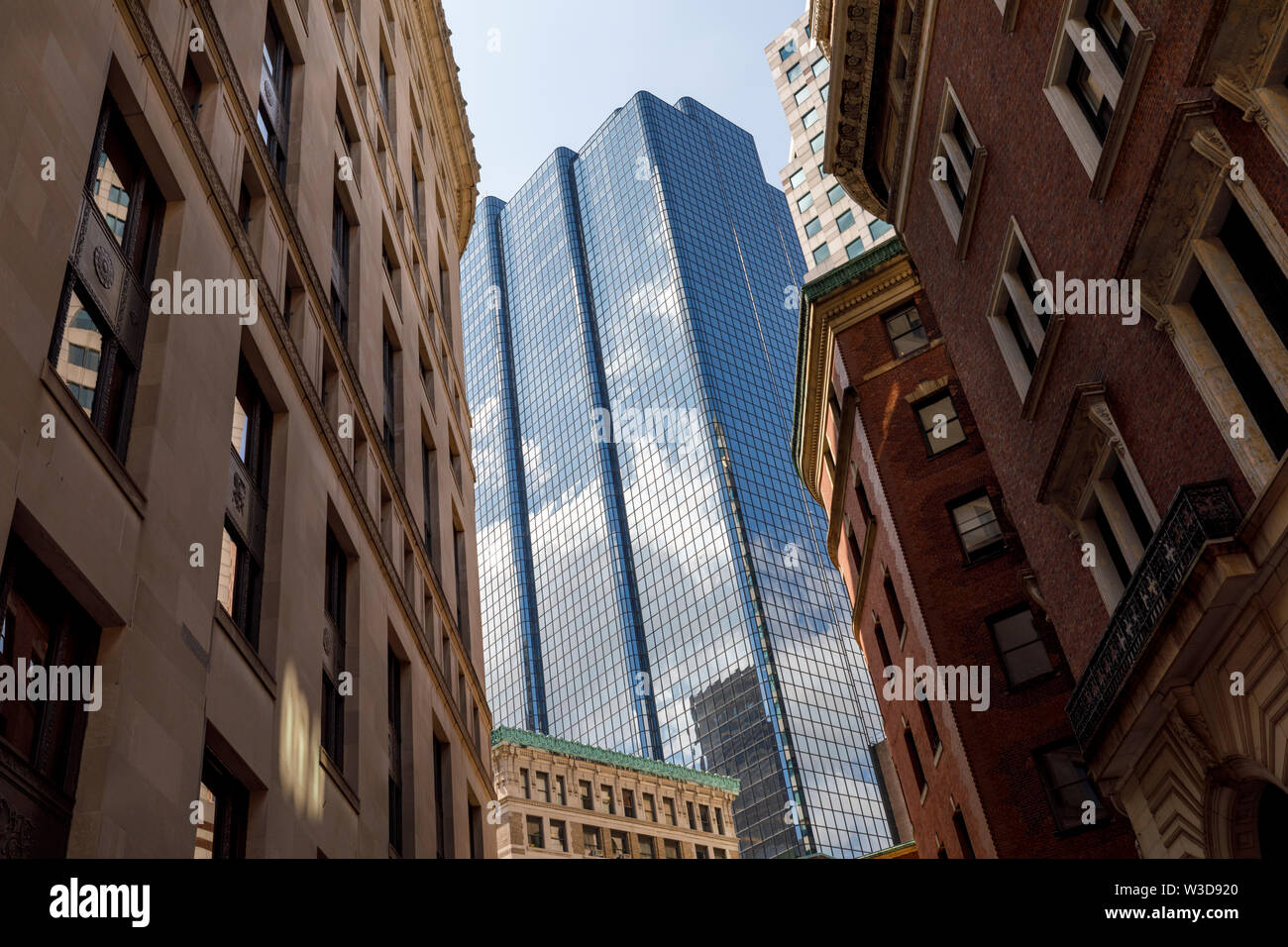 Reflective glass office building between older style architecture ...