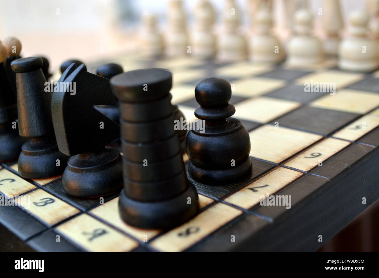 Wooden chess pieces on a chess Board Stock Photo - Alamy