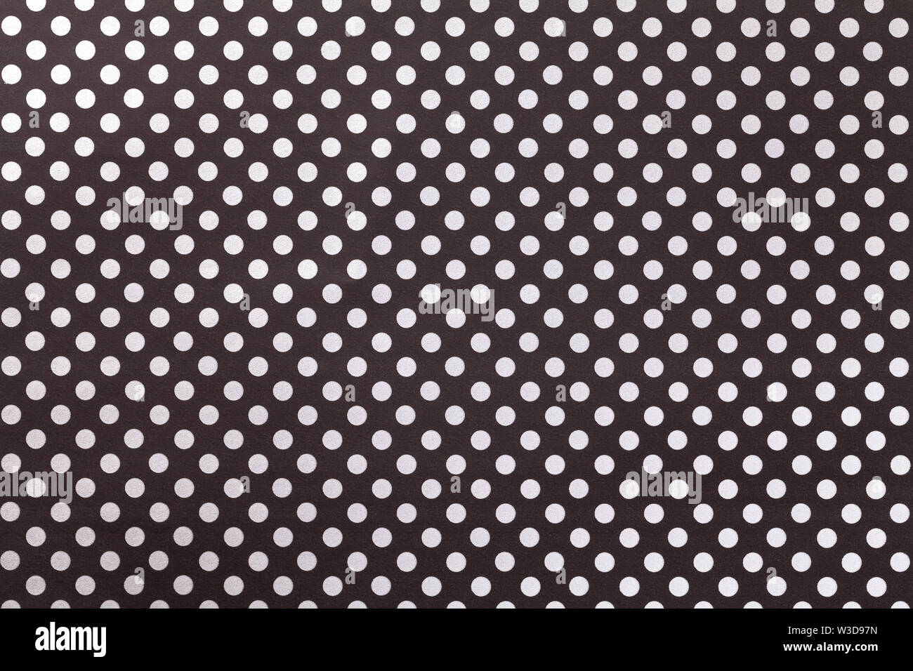 Black background from wrapping paper with a pattern of white polka dot ...
