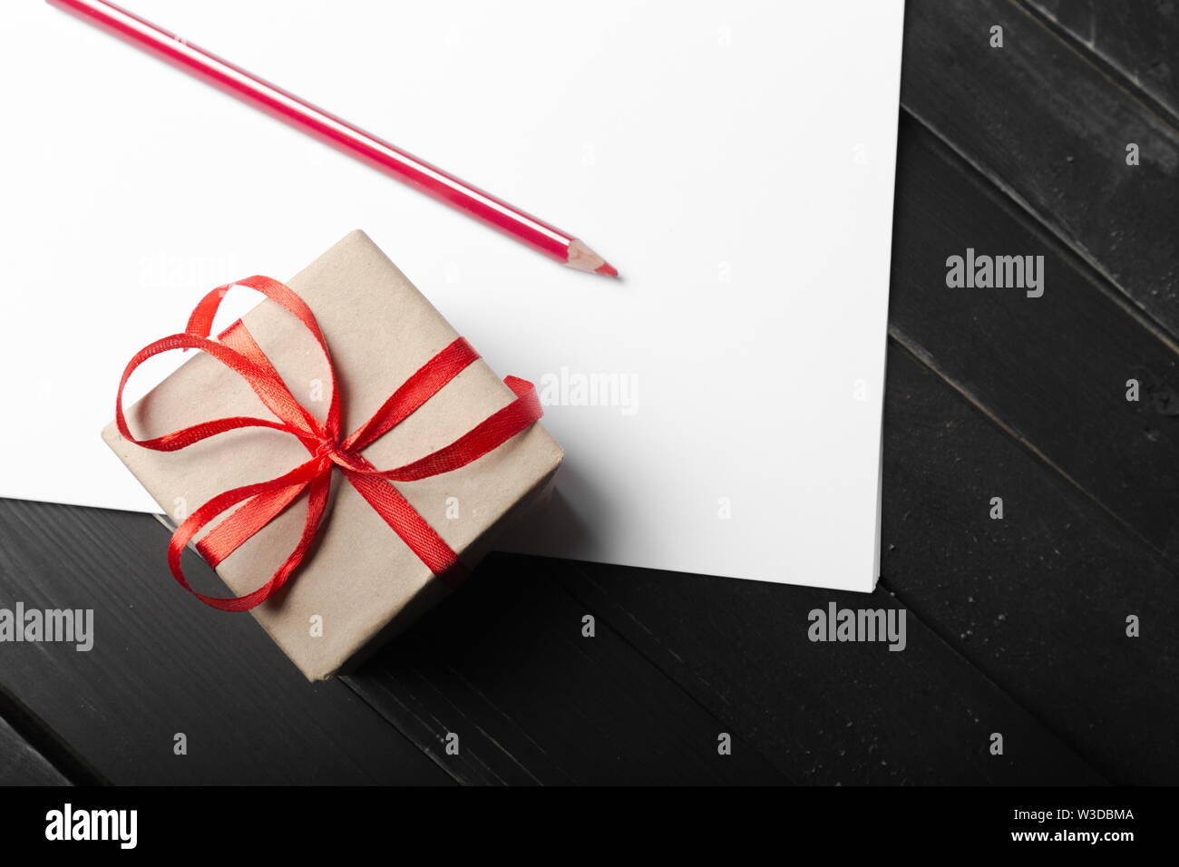 small gift box with red ribbon close up Stock Photo - Alamy