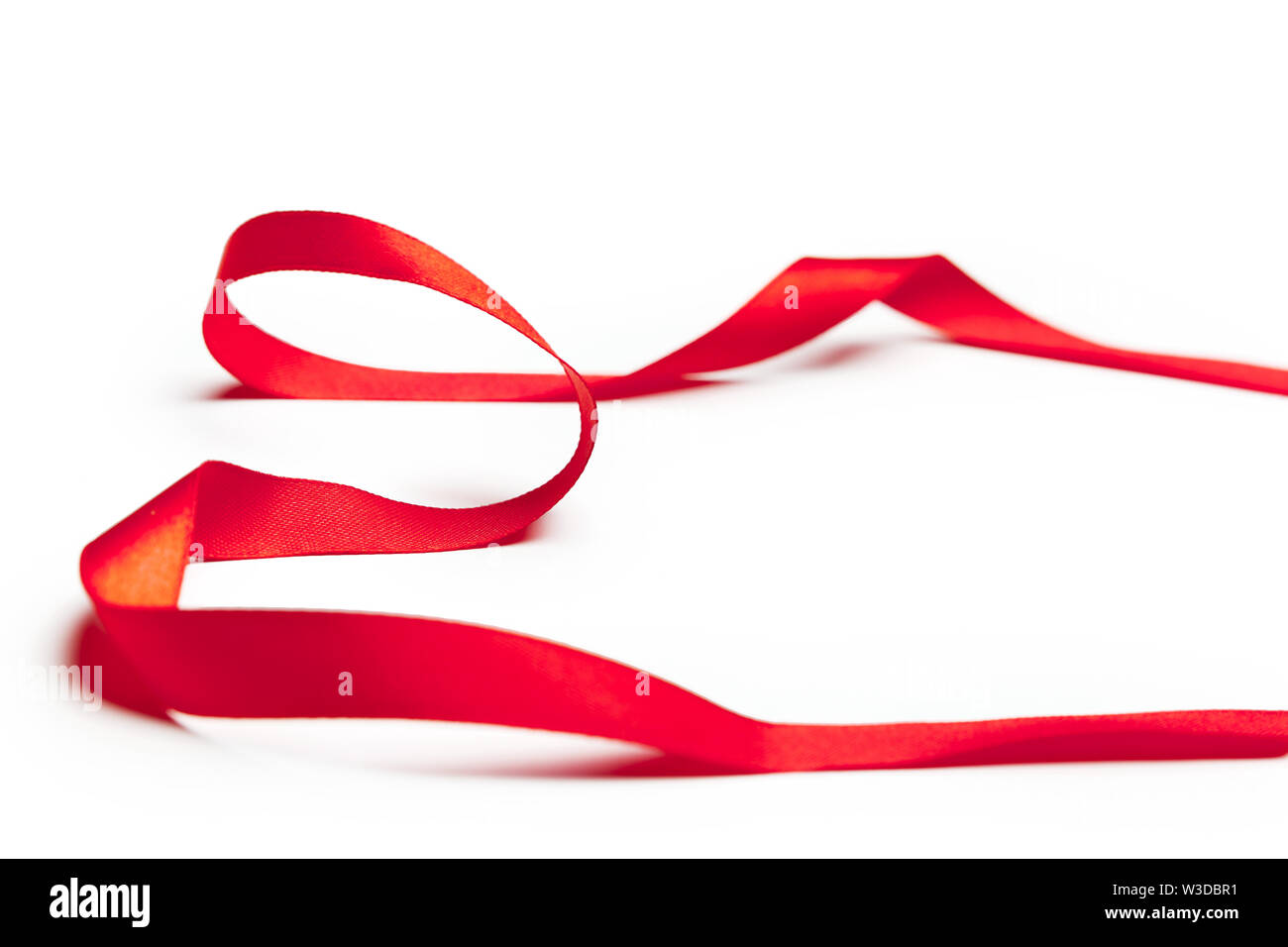 Red ribbon on white background Stock Photo - Alamy