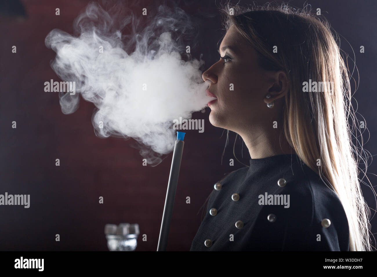 Young, beautiful girl smokes a hookah Stock Photo - Alamy