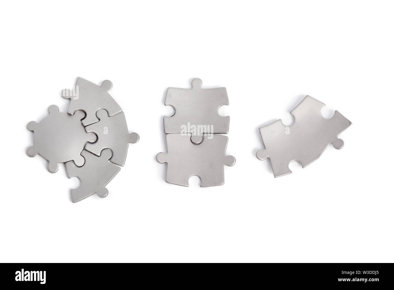 Metal puzzle pieces isolated on white Stock Photo - Alamy