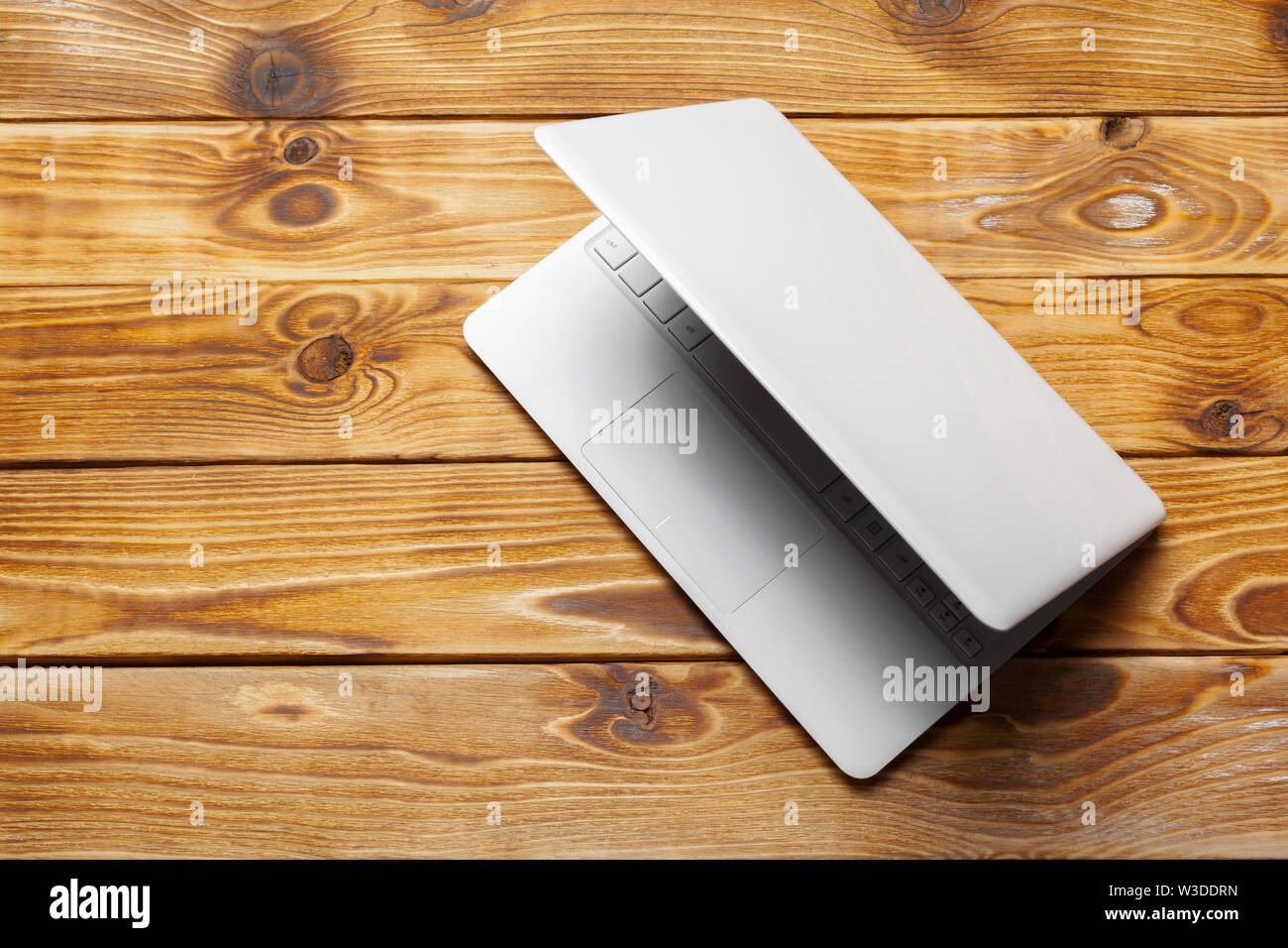 Laptop, notebook on work wooden desk Stock Photo - Alamy