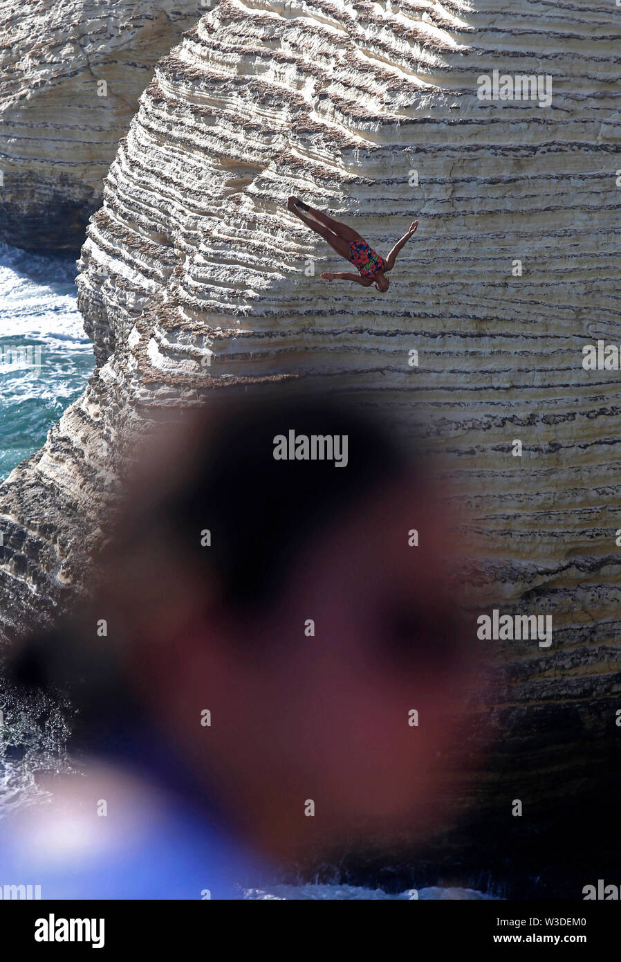 Beirut, Lebanon. 14th July, 2019. A cliff diver jumps from the landmark ...