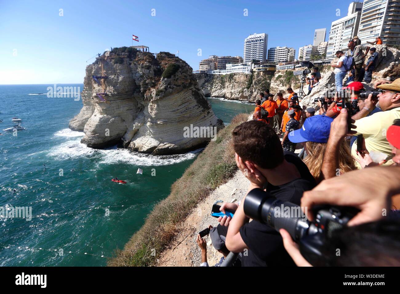 Beirut, Lebanon. 14th July, 2019. Photographers shoot a cliff diver ...