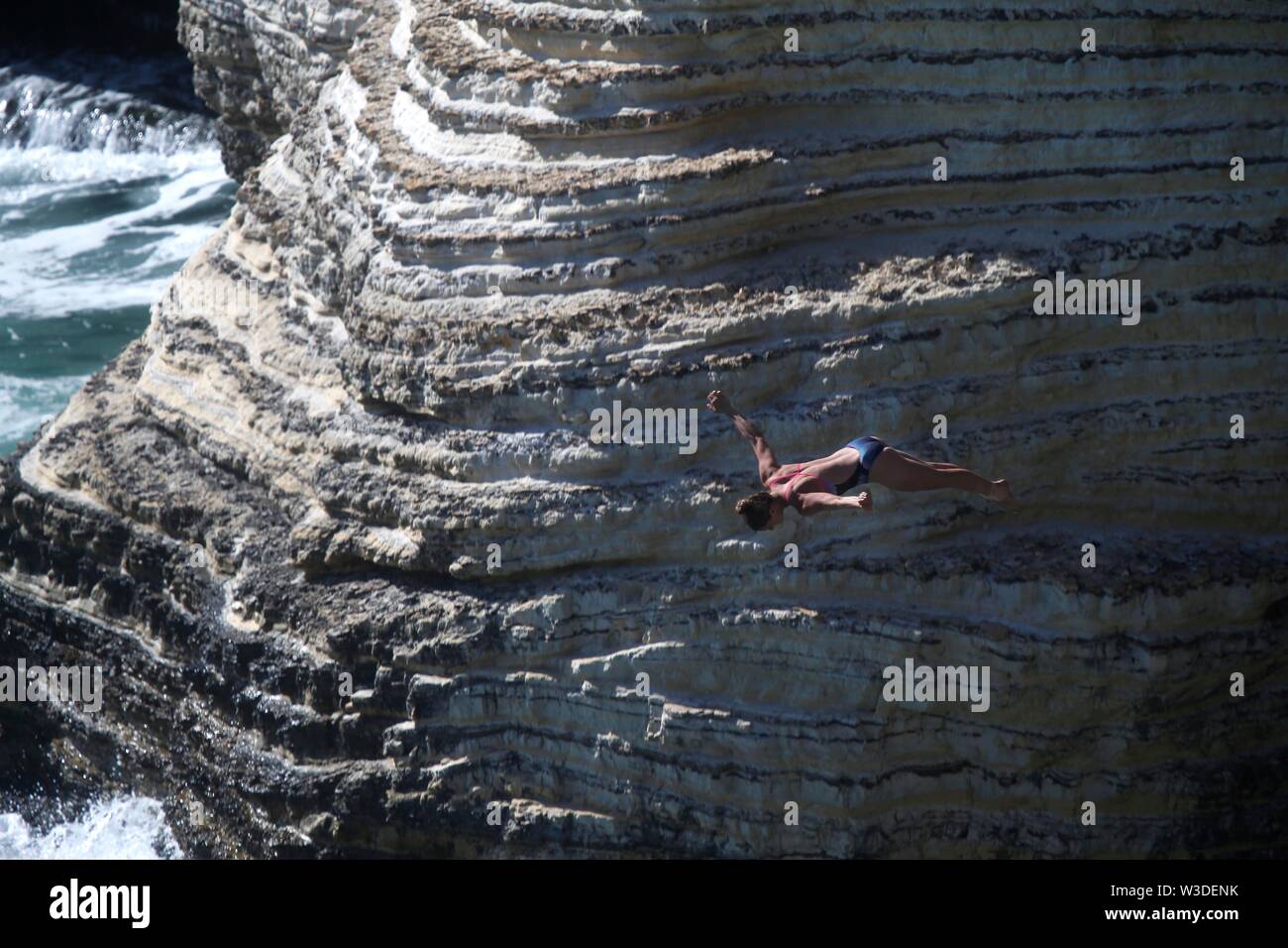 Beirut, Lebanon. 14th July, 2019. A cliff diver jumps from the landmark ...