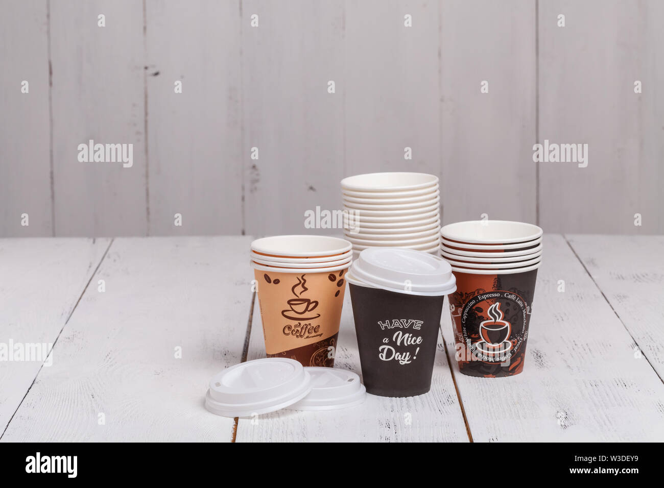 Paper cups of coffee on wooden texture background Stock Photo - Alamy