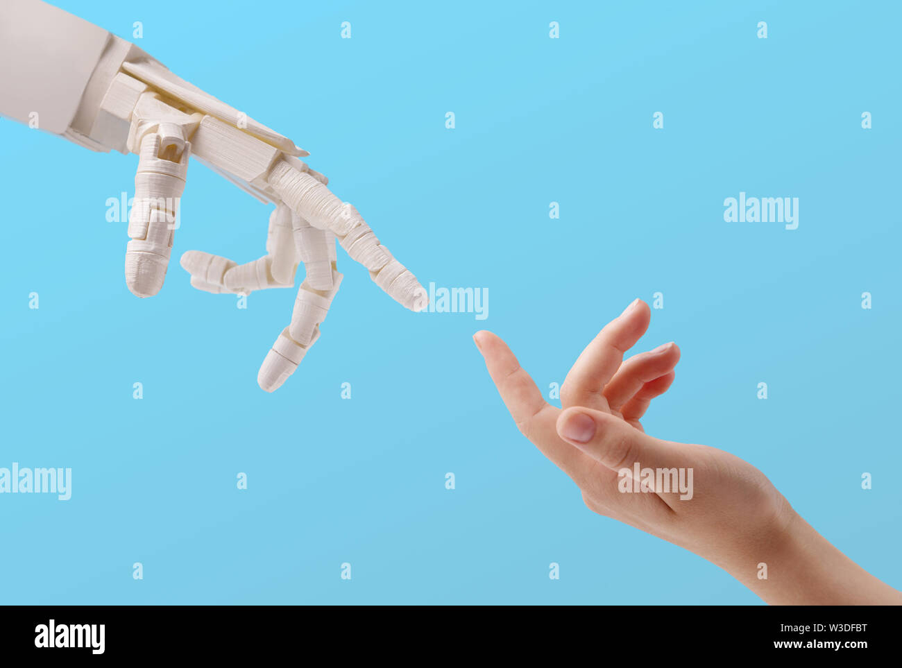Female hand and robot reaching to each other on blue Stock Photo - Alamy