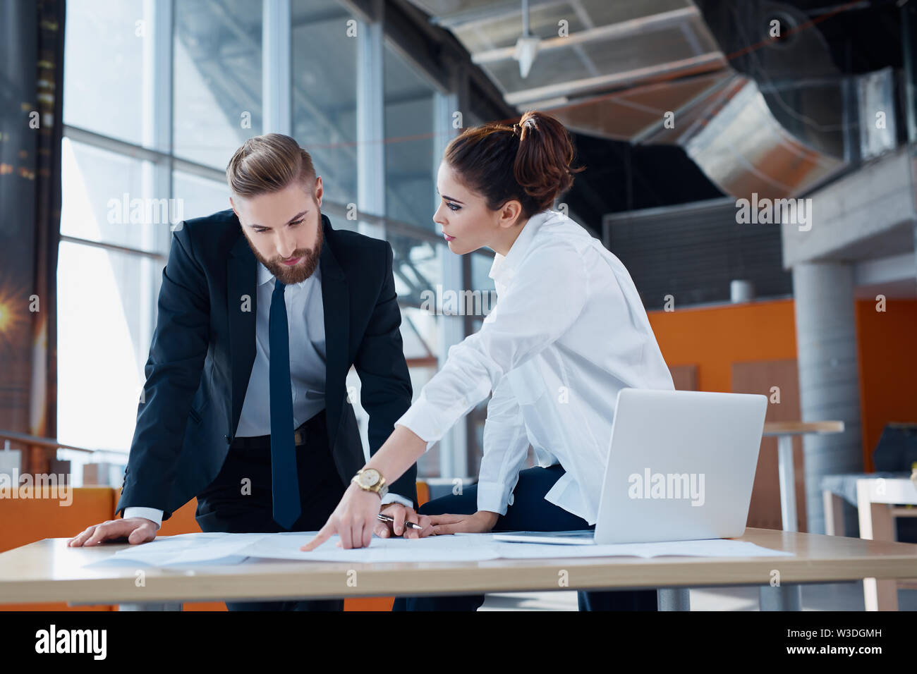 Business partners working on new project at modern office Stock Photo ...