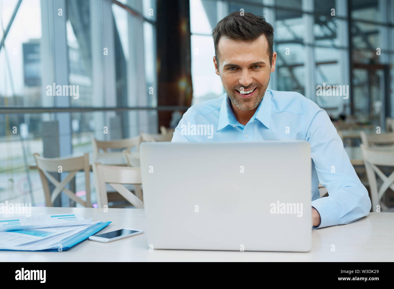 Cheerful businessman typing on notebook hi-res stock photography and ...