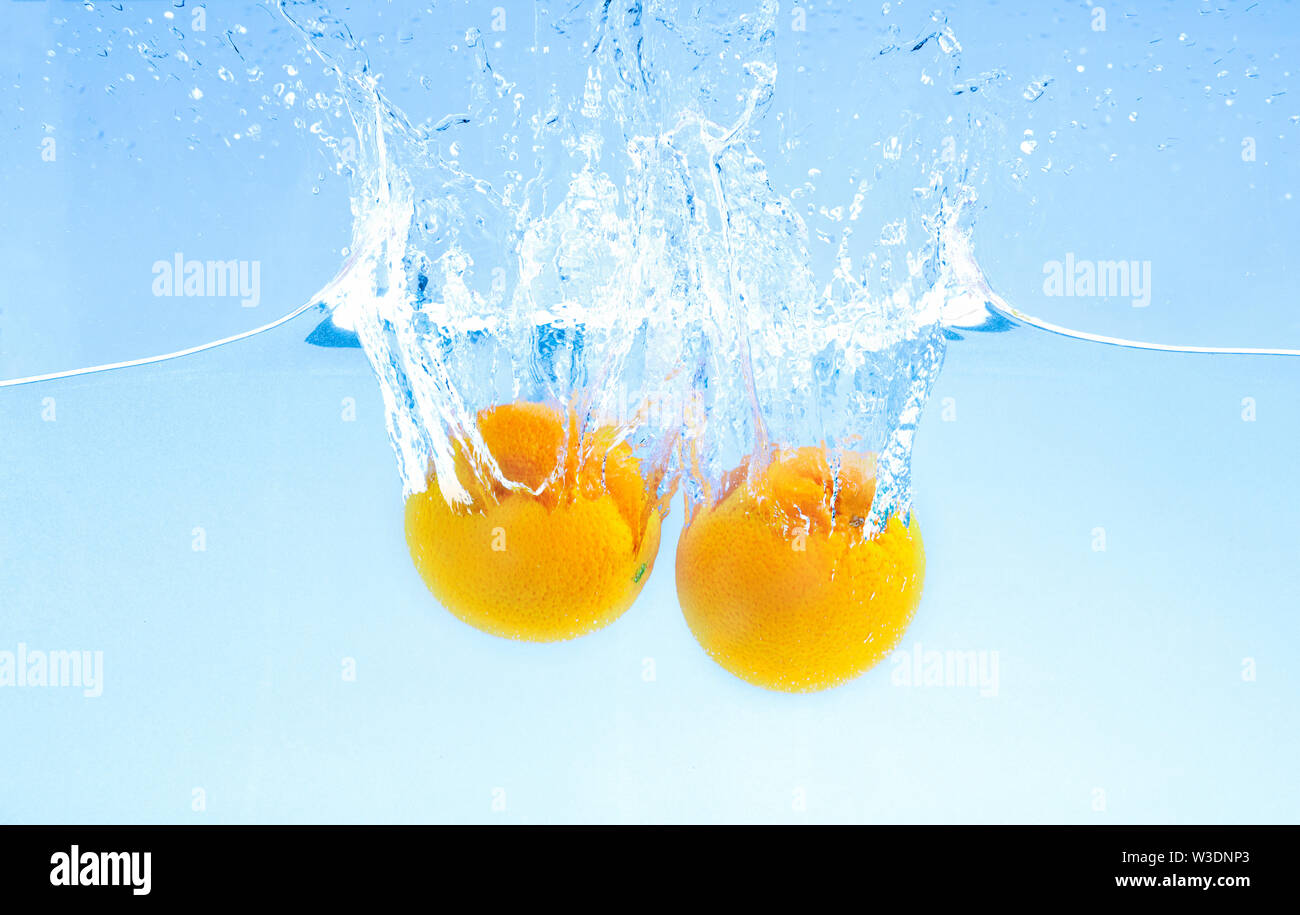 Two ripe oranges falling deeply under water with big splash Stock Photo ...