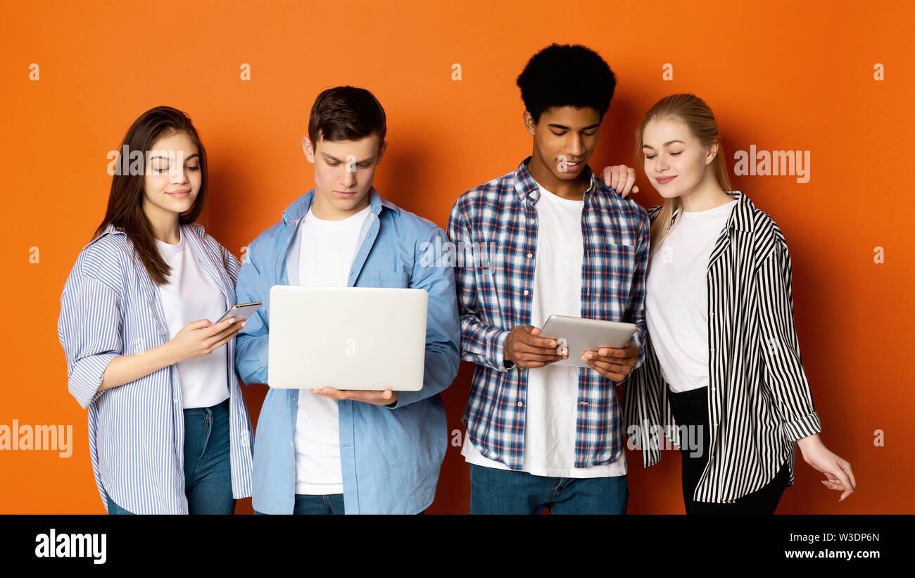 Group of friends using laptop and tablet Stock Photo - Alamy