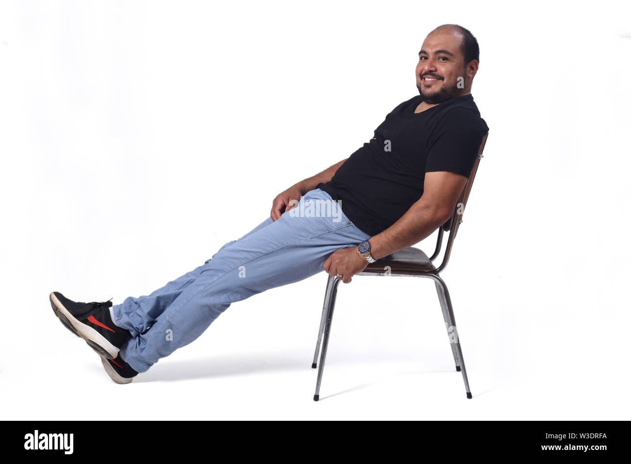 full portrait of a south american man sitting on a chair on white Stock ...