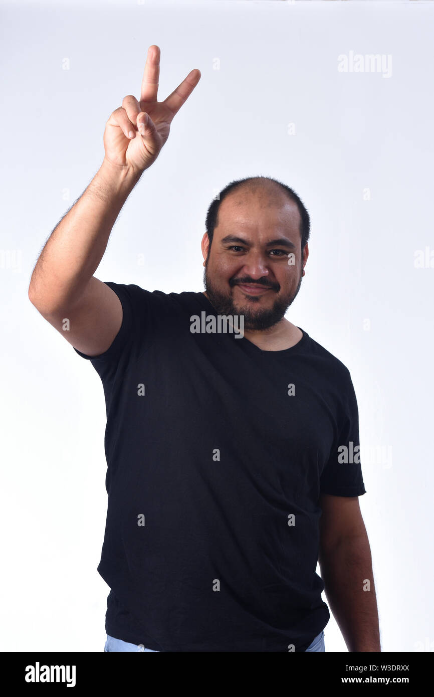 Latin american man making the victory sign on a white background Stock ...