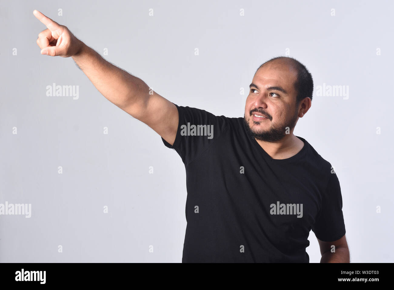 portrait of a latin american man pointig on white background Stock ...