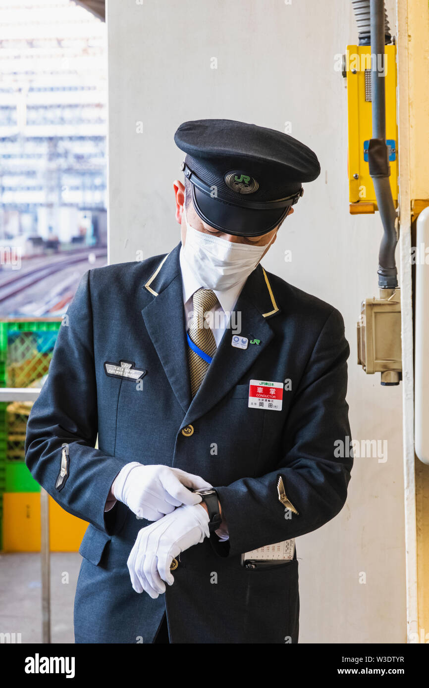 Japan, Honshu, Tokyo, Japan Railways (JR), Train Guard Checking Watch ...
