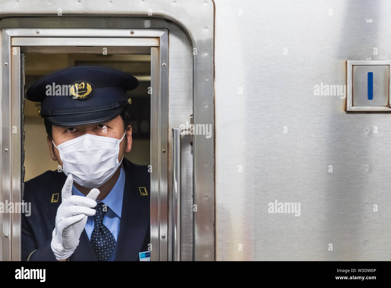 Japan, Honshu, Tokyo, Subway, Train Guard Wearing Allergy Mask Stock ...