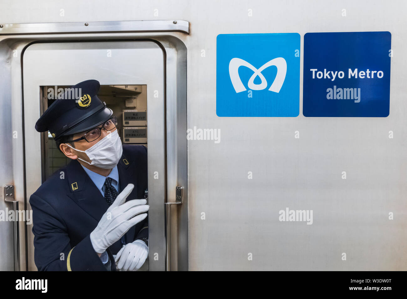Japan, Honshu, Tokyo, Subway, Train Guard Wearing Allergy Mask Stock ...