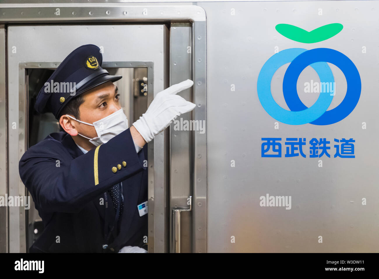 Japan, Honshu, Tokyo, Subway, Train Guard Wearing Allergy Mask Stock ...