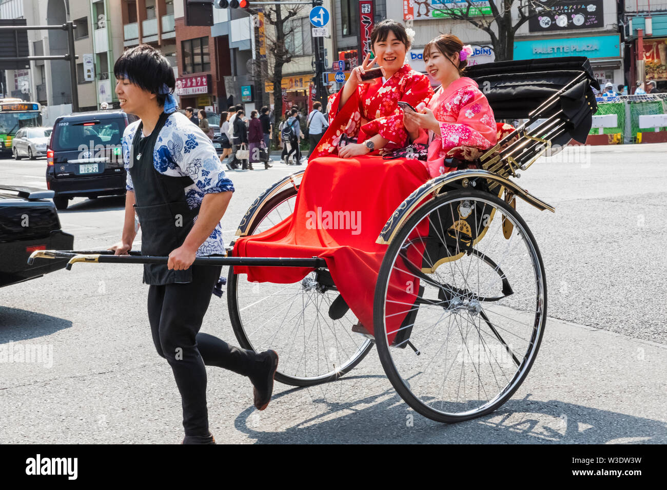 Japan, Honshu, Tokyo, Asakusa, Two Young Women Dressed in Kimono Riding ...