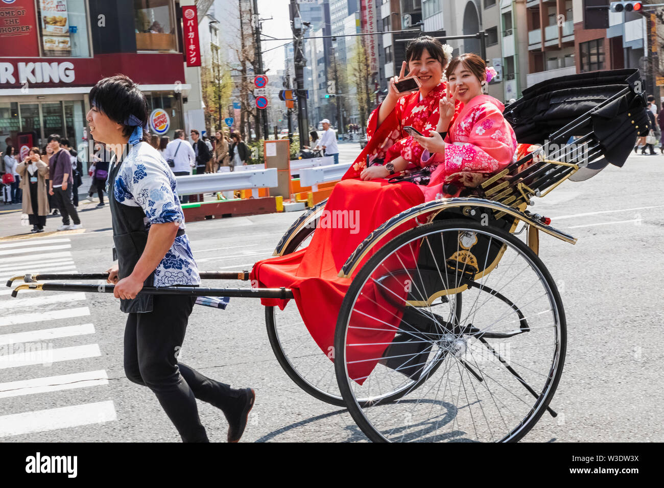Japan, Honshu, Tokyo, Asakusa, Two Young Women Dressed in Kimono Riding ...