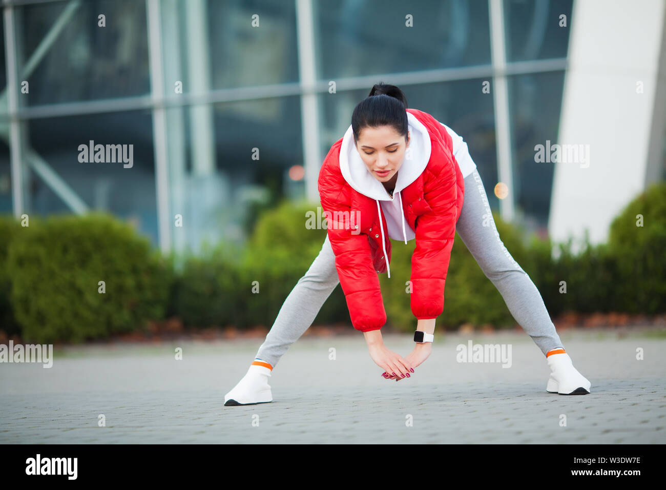 Fitness woman doing workout standing in a stadium background Stock ...
